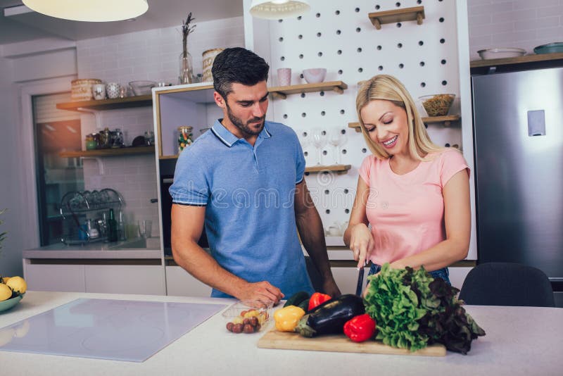Couple Making Lunch Together in Their Kitchen at Home Stock Image ...