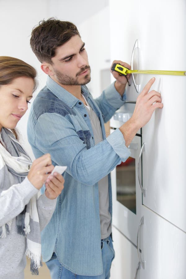 Couple Measuring Kitchen Cabinet with Tape Ruler Stock Image - Image of ...