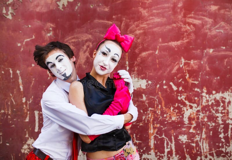 Couple Mimes Cute Pose in Front of a Red Wall Stock Image - Image of ...