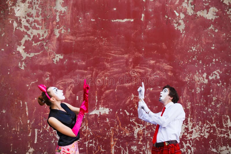 Couple Mimes Point To the Top on a Red Wall. Stock Image - Image of ...