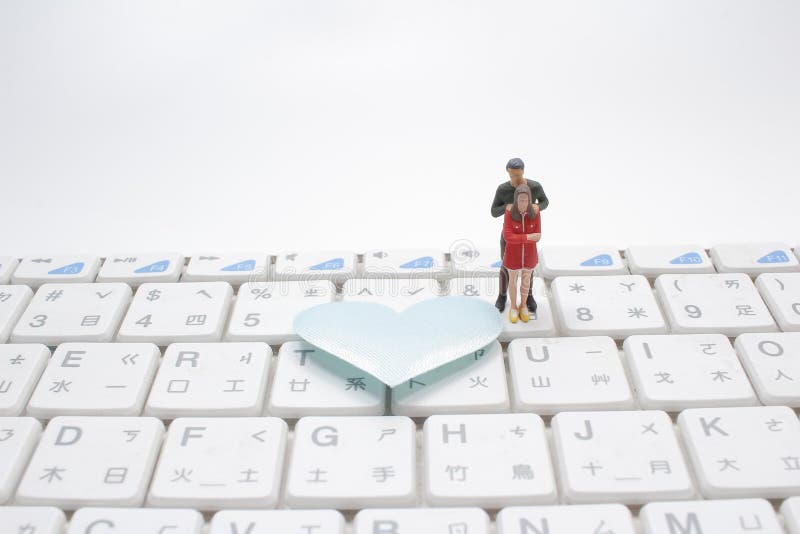 A Couple of Mini Figure Lover and Big Heart on White Keyboard Stock ...