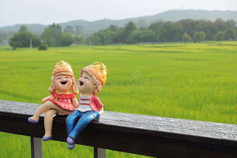 A Couple of Model Sitting Together in the Rice Field Stock Photo ...