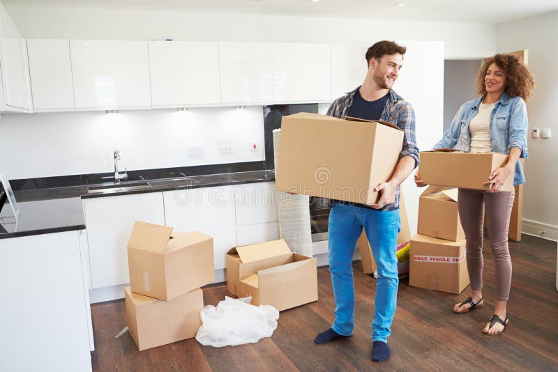 Couple Moving into New Home and Unpacking Boxes Stock Photo - Image of ...