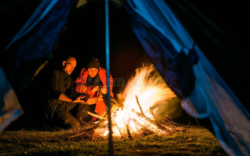 Couple Near Camp Fire Warming Up Stock Image - Image of camping ...