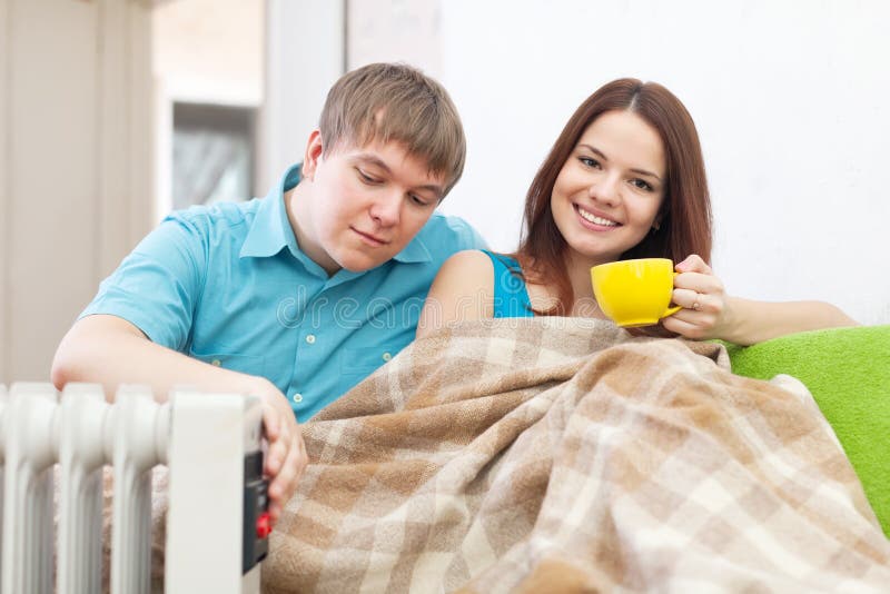 Couple Near Warm Radiator in Home Stock Photo - Image of adult ...