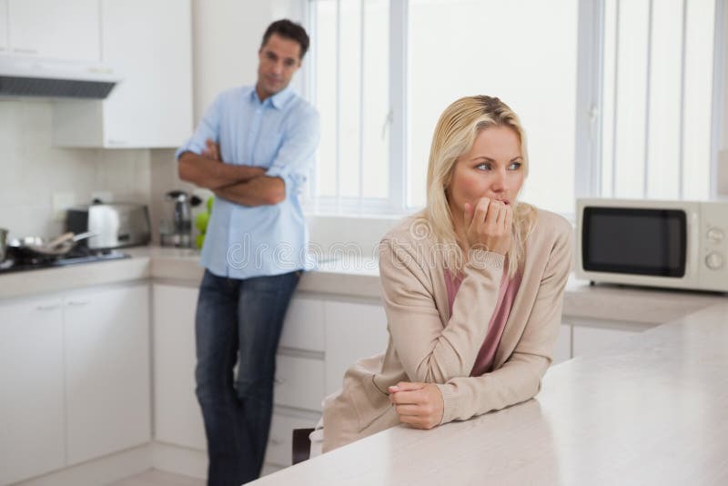 Couple Discussing Personal Finances in Kitchen Stock Photo - Image of ...