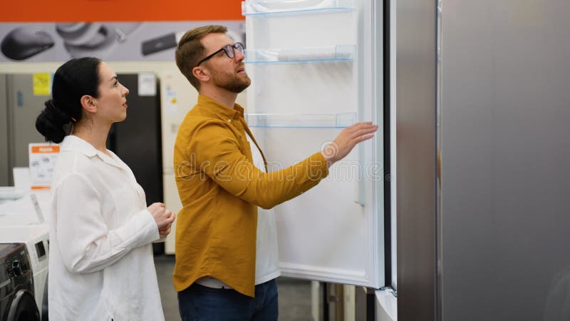 Couple Open Door of the Refrigerator in the Hardware Electronics Store ...