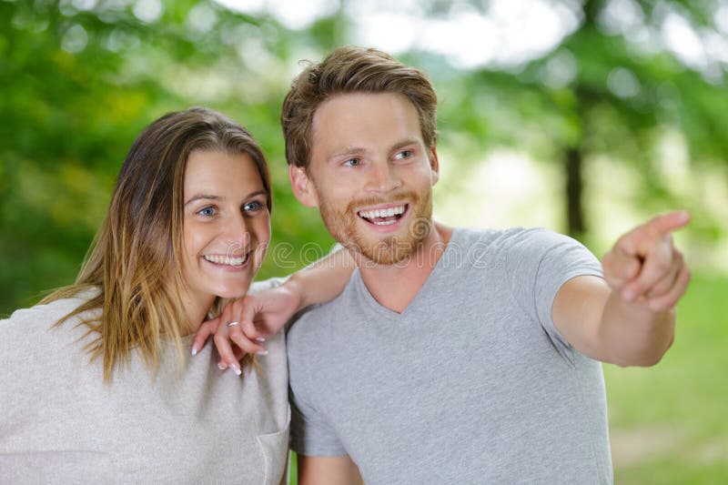 Couple Out Walking Man Pointing into Distance Stock Photo - Image of ...
