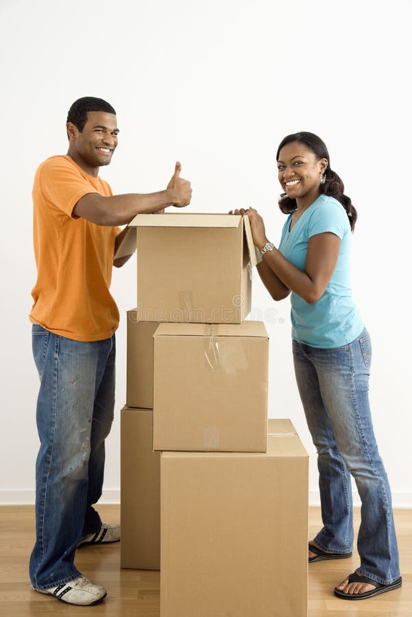 Couple packing boxes. stock image. Image of smiling, full - 6152133