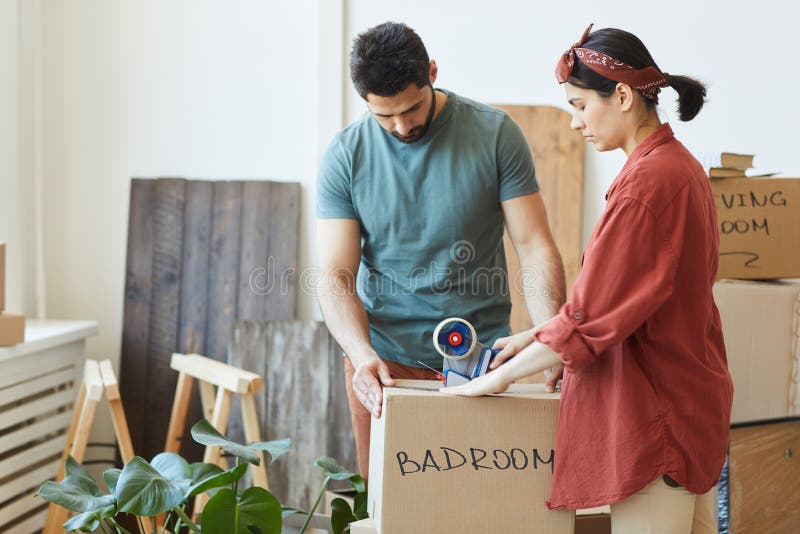 Couple Packing Things Together Stock Photo - Image of working ...