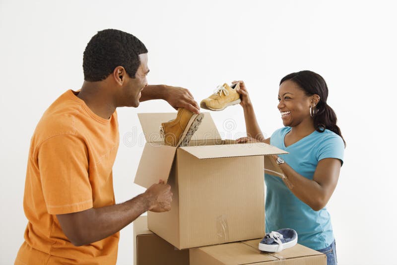 Couple packing boxes. stock image. Image of smiling, full - 6152133