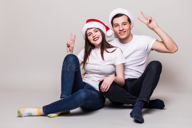 Couple with Peace Sign and Christmas Hats Stock Photo - Image of ...