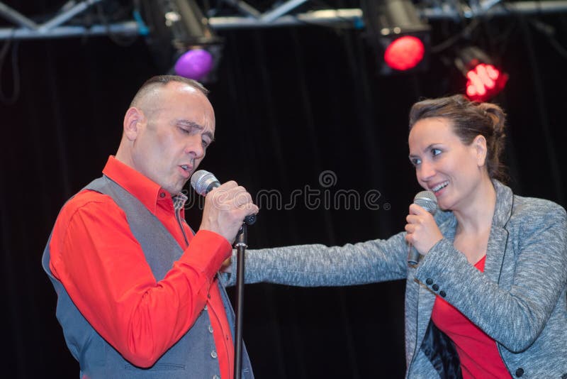Couple performing on stage stock photo. Image of concert - 103621458