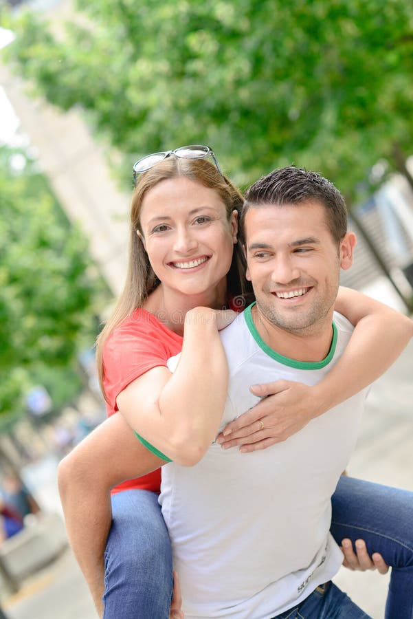 Couple on piggy back stock image. Image of leisure, outdoors - 276720575