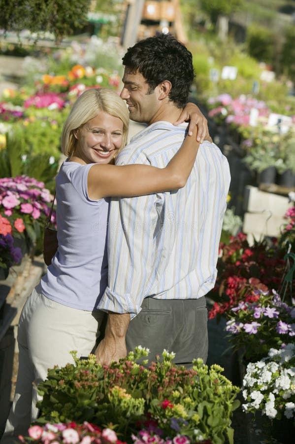 Couple at Plant Nursery Hugging Stock Photo - Image of plant, potted ...