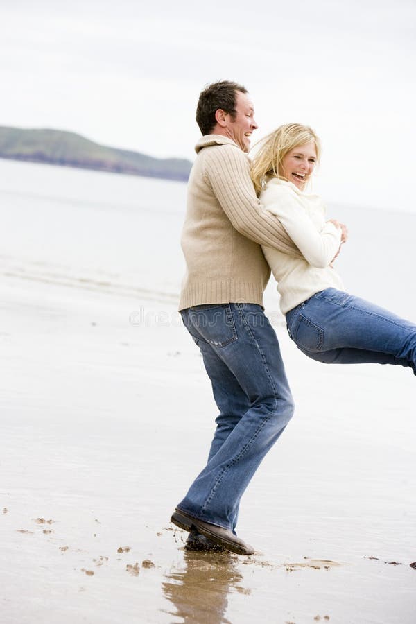 Couple Chasing One Another through Dunes Stock Photo - Image of ...