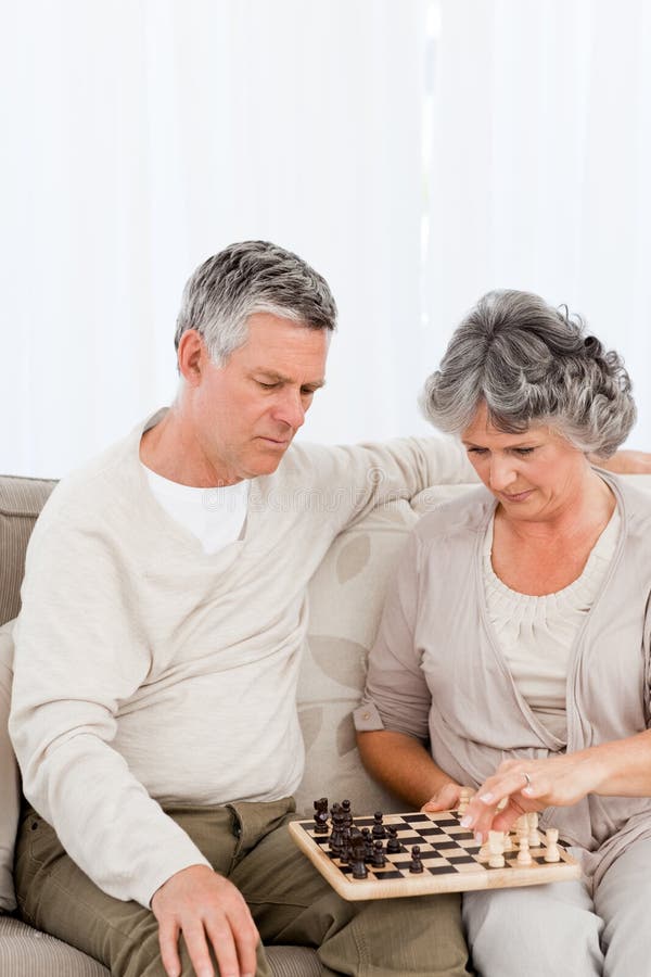 Couple Playing Chess on Their Sofa Stock Image - Image of maturity ...