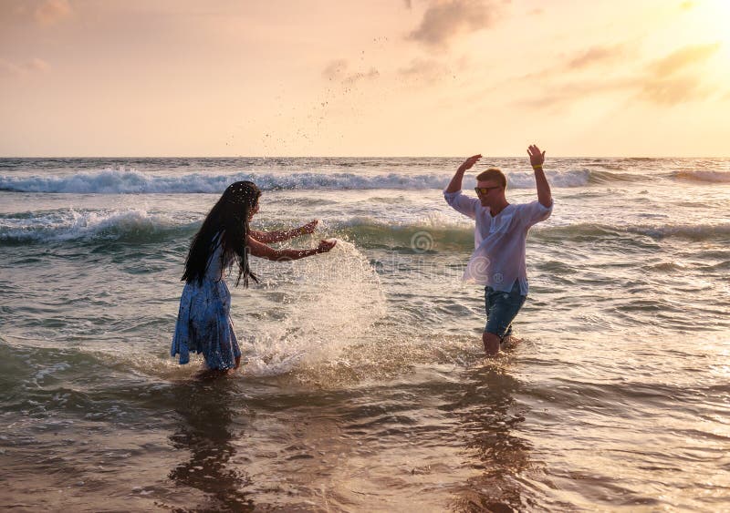 Couple Playing in the Ocean Stock Image - Image of holidays, holiday ...
