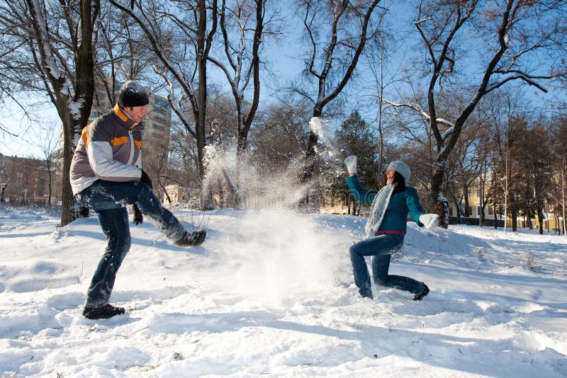 Couple playing with snow stock image. Image of embracing - 12942047