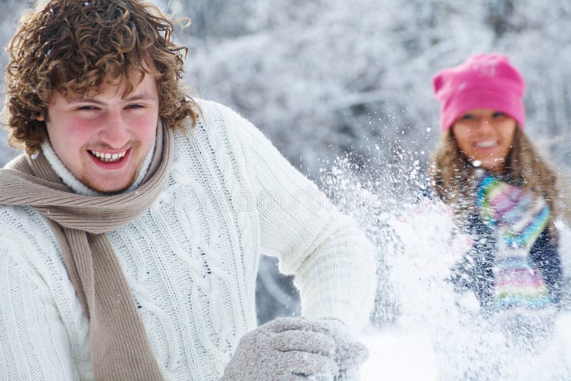Couple playing snowballs stock image. Image of beauty - 16937909