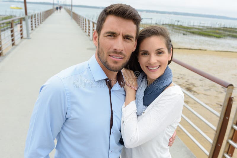 Couple posing on bridge stock image. Image of happy - 260341583