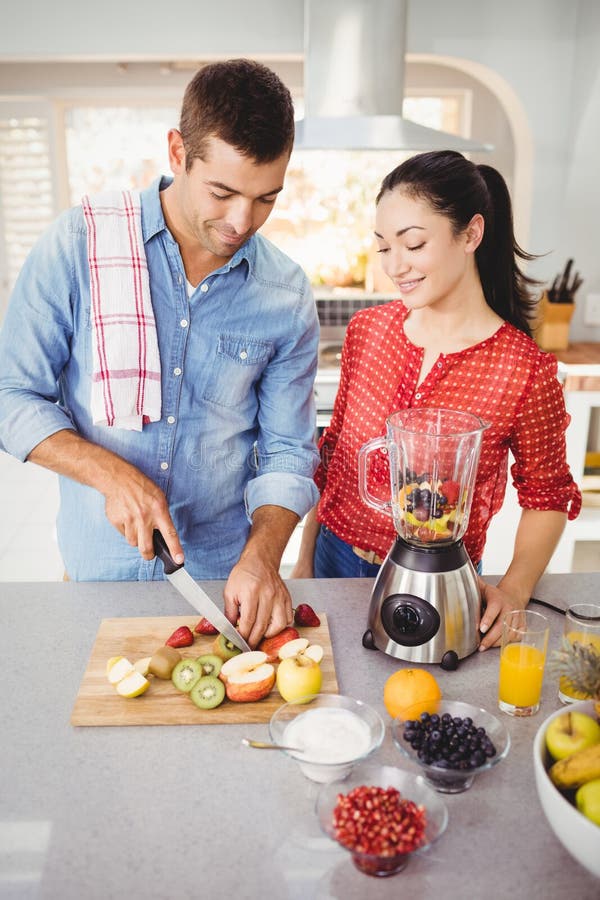 Couple Preparing Fruit Juice while Standing at Table Stock Image ...