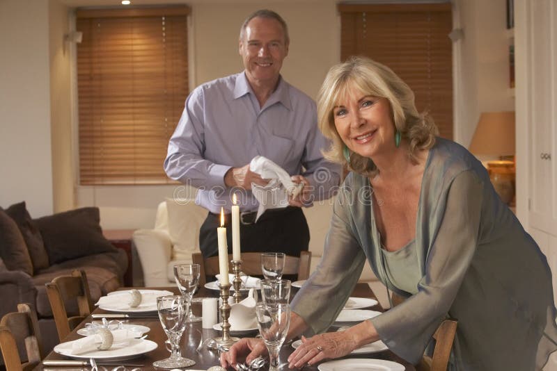 Couple Preparing Table for a Dinner Party Stock Photo - Image of ...
