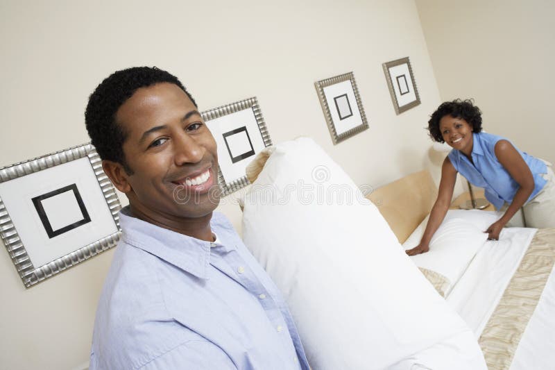 Couple Preparing Their Bed stock photo. Image of people - 29651634