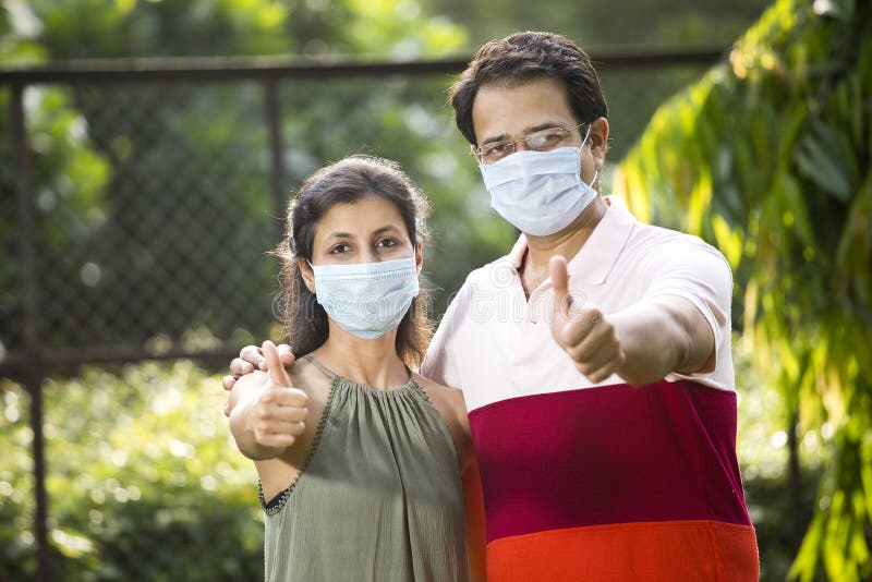Couple with Protective Face Mask at Park Stock Photo - Image of ...