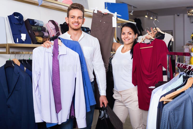 Couple Purchasing Clothes for Two in Boutique Stock Image - Image of ...