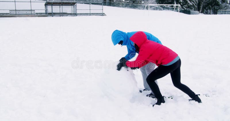 Couple Pushing a Huge Snowball Stock Footage - Video of love, highdef ...