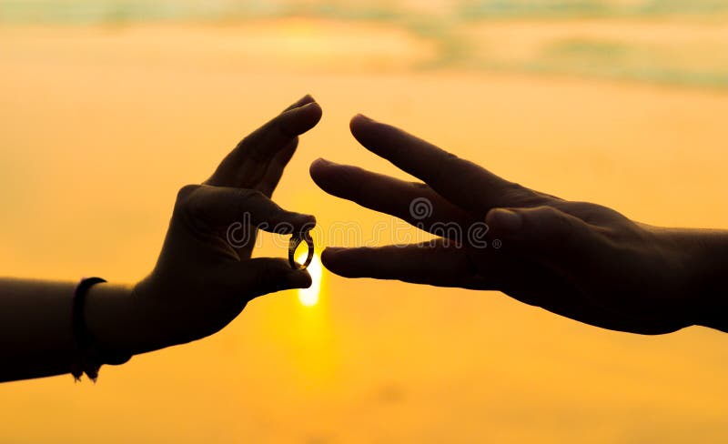Couple Putting Engagement Ring into Ring Finger of Other. Romantic ...