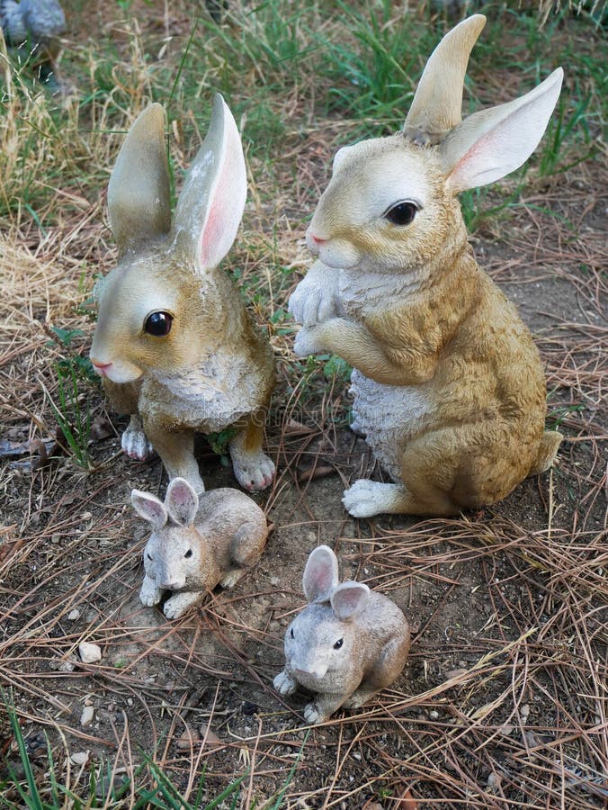 Couple of Rabbits and Their Young Easter Bunnies Resting in a Garden ...