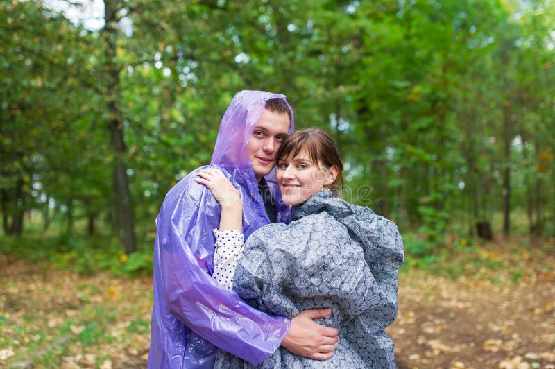Couple in Raincoats Embracing on Autumn Forest Stock Image - Image of ...