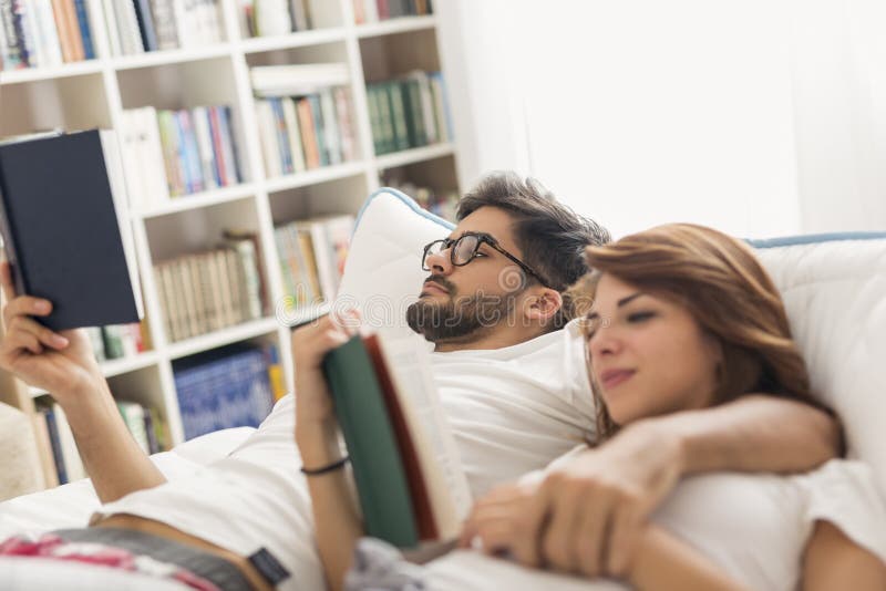 Couple reading in bed stock photo. Image of closeness - 110478858