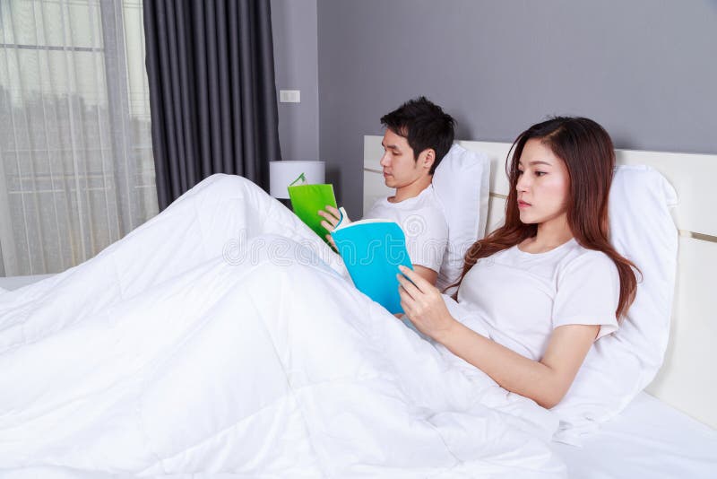 Couple Reading a Book on Bed in the Bedroom Stock Image - Image of ...