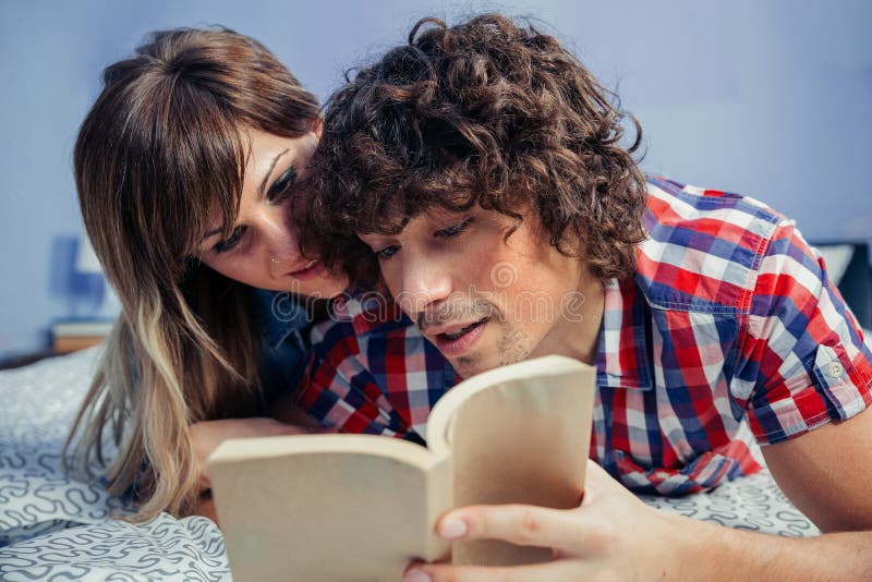 Couple Reading a Book on the Bed Stock Image - Image of cheerful ...