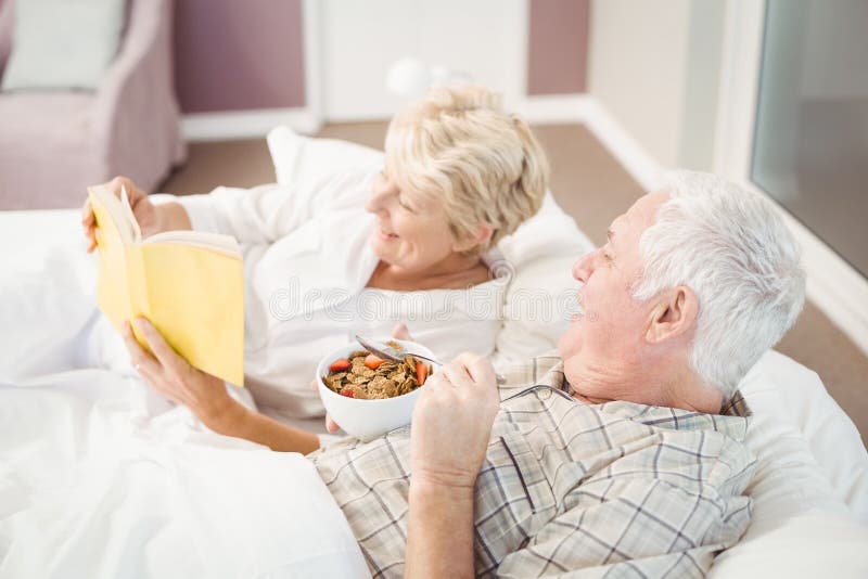 Couple Reading Book while Having Breakfast on Bed Stock Image - Image ...