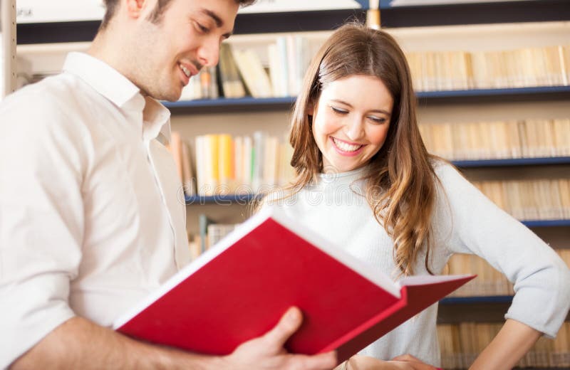 Couple Reading a Book in a Library Stock Image - Image of library, book ...
