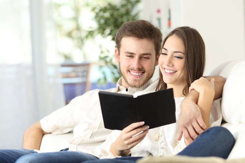 Couple Reading a Guide in an Ebook Stock Image - Image of holding ...
