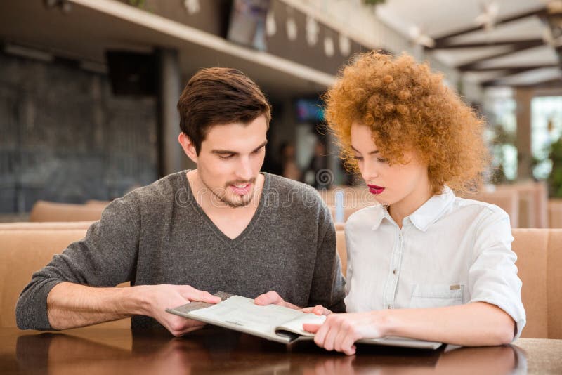 Couple Reading Menu in Restaurant Stock Image - Image of girlfriend ...