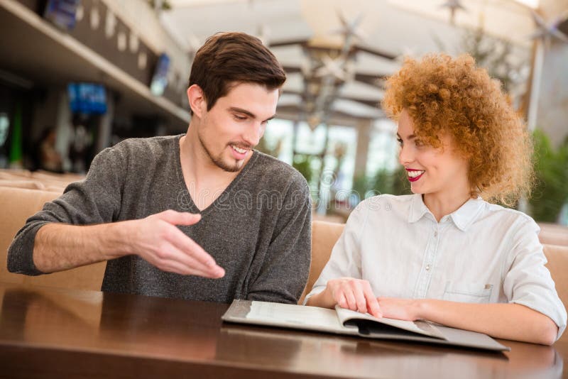 Couple Reading Menu in Restaurant Stock Photo - Image of dinner ...