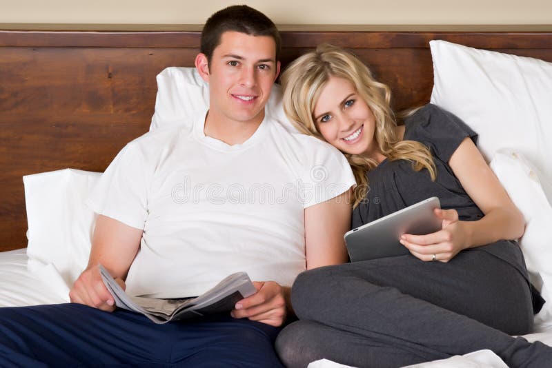 Couple Reads Tablet Computers in Bed Stock Image - Image of pajamas ...