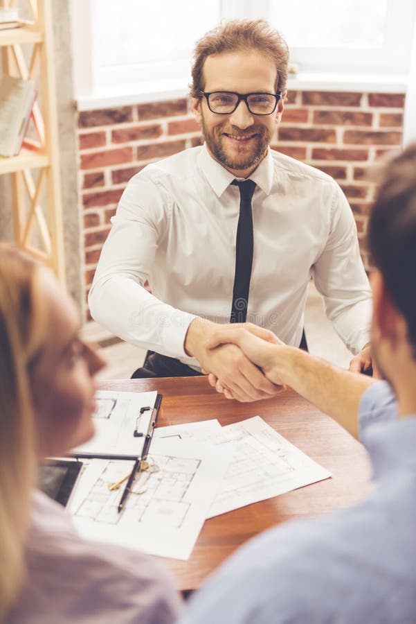 Couple and a realtor stock photo. Image of management - 81938794
