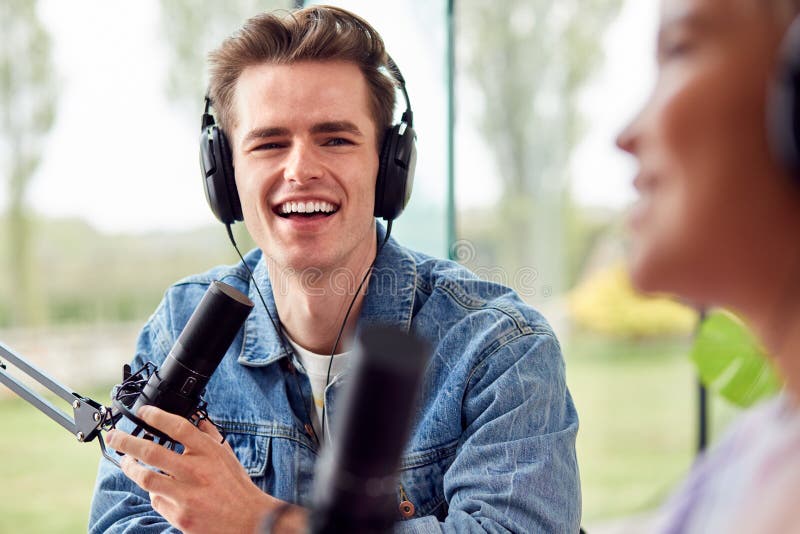 Couple Recording Podcast or Broadcasting Interview on Radio in Studio ...