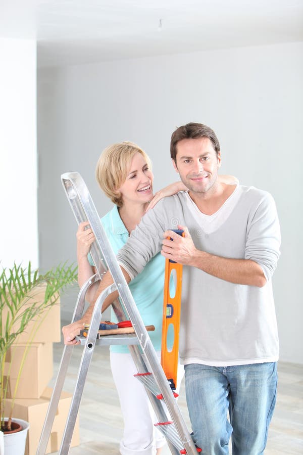 Couple redecorating home stock photo. Image of blond - 22249774
