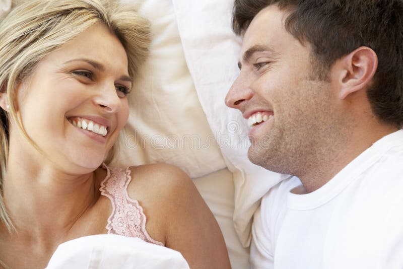 Couple Relaxing in Bed stock image. Image of adult, cuddling - 54972219