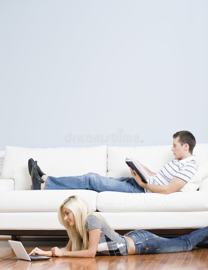 Couple Relaxing in Living Room Stock Photo - Image of computer, adult ...