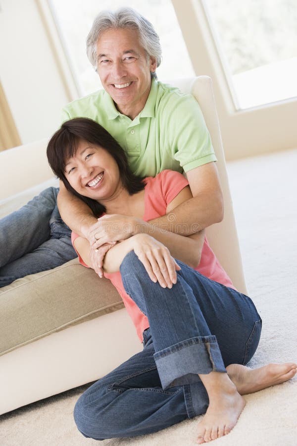 Couple Relaxing in Living Room and Smiling Stock Photo - Image of ...