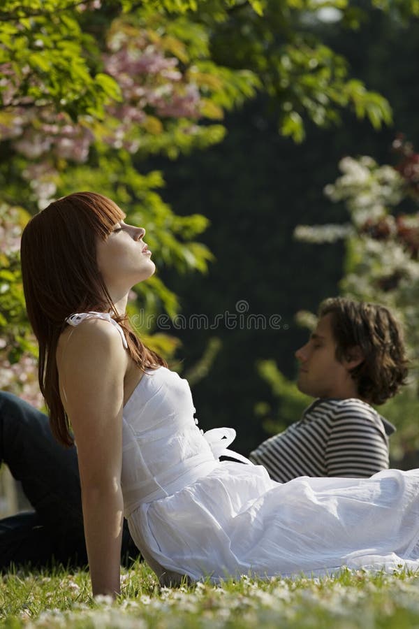 Couple Relaxing in Park stock photo. Image of outdoors - 33892292